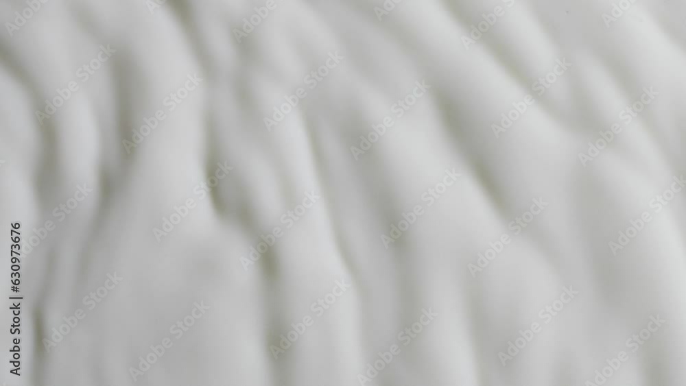 Slow motion white liquid cream ripples, close-up fresh milk drink ...