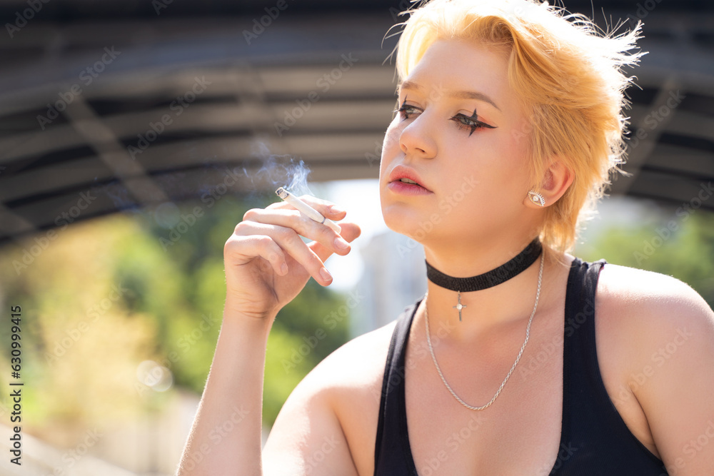 glamorous girl with short hair and makeup smoking a cigarette. Stock ...