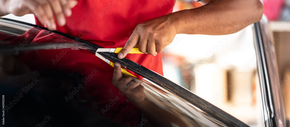 Car side window film removal and tinting installation. Male auto ...