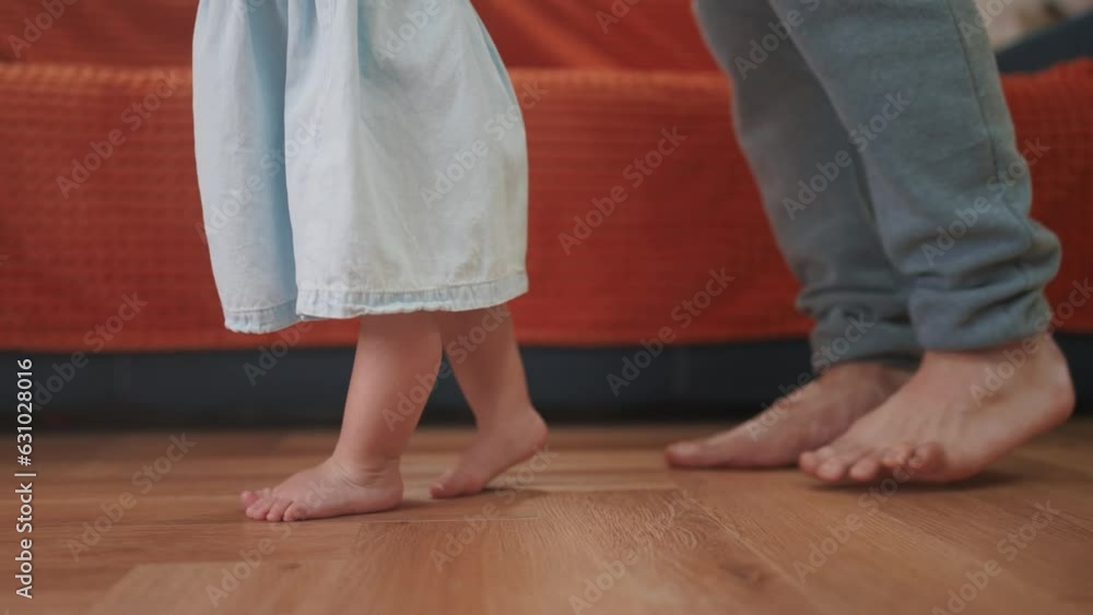 baby first steps. daddy a teaches baby toddler daughter to take first ...