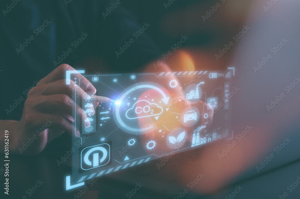 Hand touching CO2 reducing icon in concept of decrease carbon dioxide emission ,carbon footprint ...