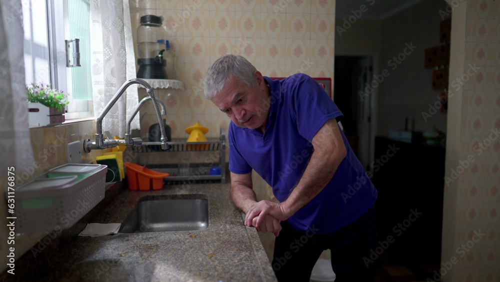 Stressed senior man leaning on kitchen sink struggling in despair at ...