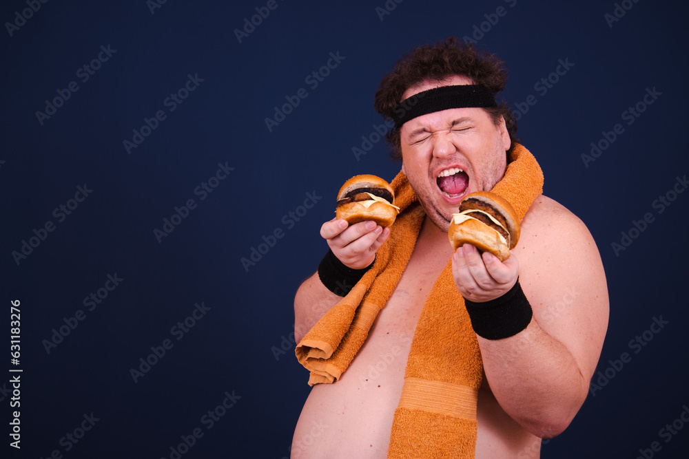 Funny hungry fat man eating burger. Stock Photo | Adobe Stock