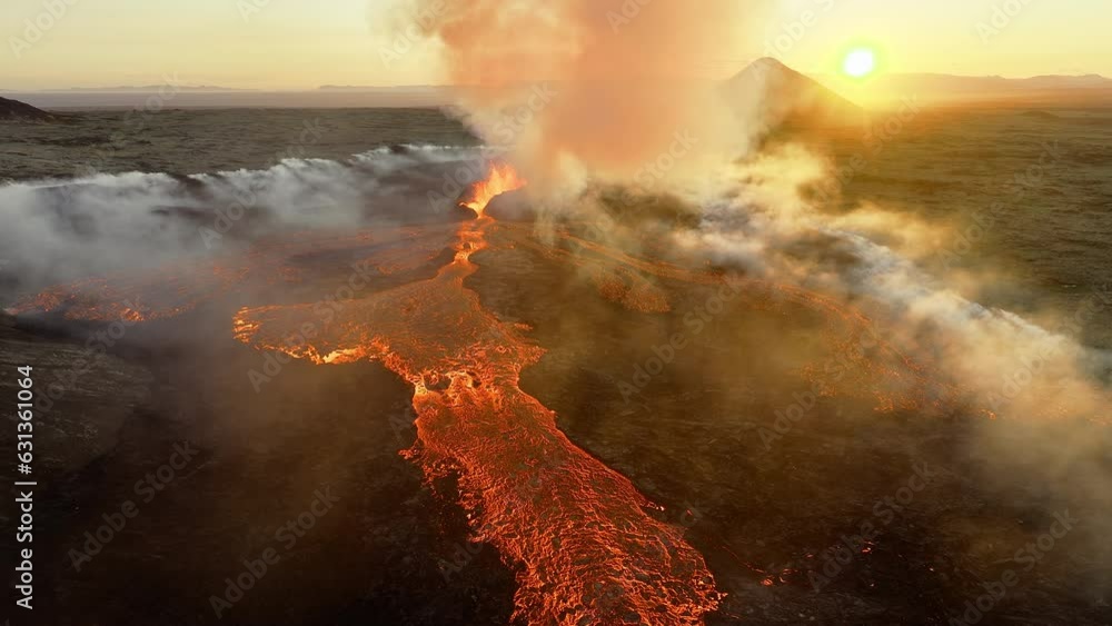 Volcano eruption, branching lava stream flowing down on volcano slope ...