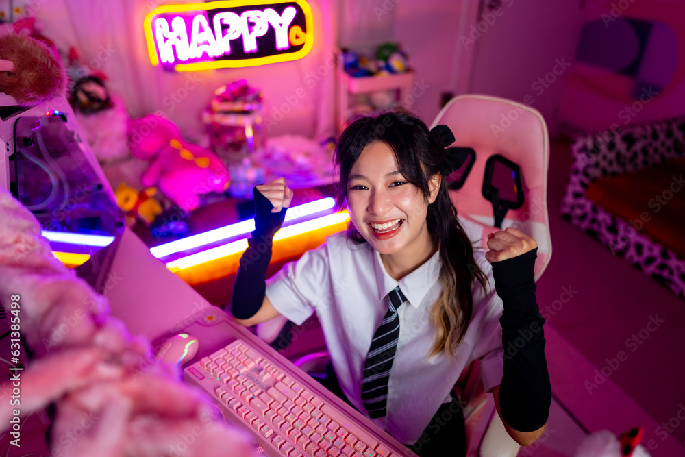 Young Asian woman Esports player playing online game on computer in ...