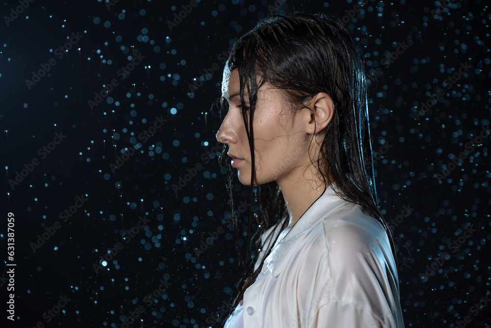 young woman in the rain, getting wet through, wet clothes and water running down her face. Stock ...