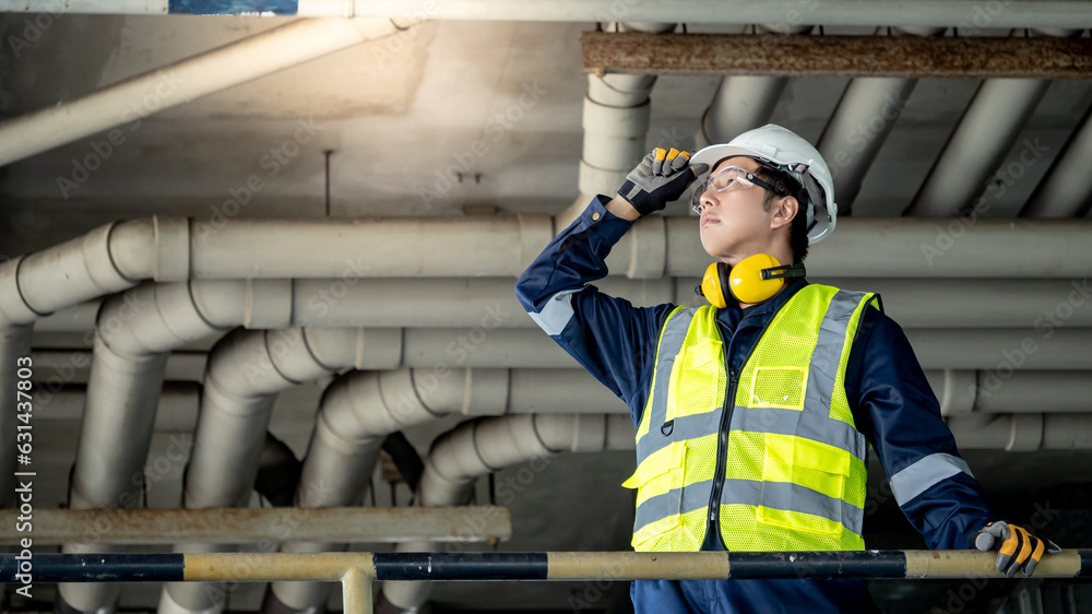 Asian man inspection engineer holding his safety helmet while looking ...