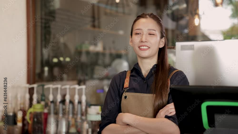 4k, portrait smiling barista woman arms crossed standing at counter ...