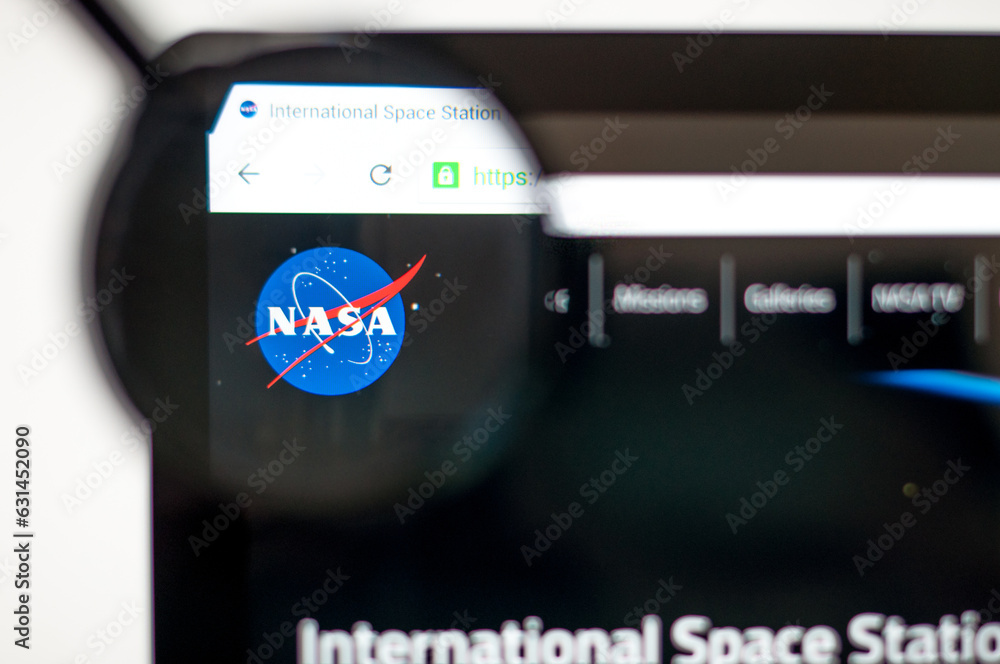 Nasa homepage through a magnifying glass. NASA is the agency of the US ...
