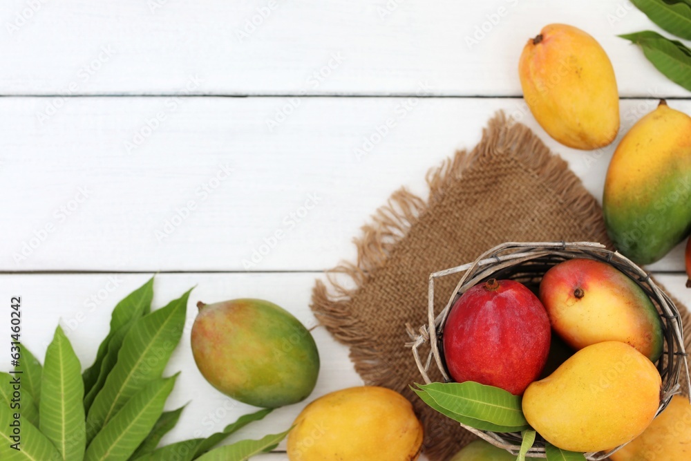 Ripe mango on kitchen table, white wooden background, free space, place ...