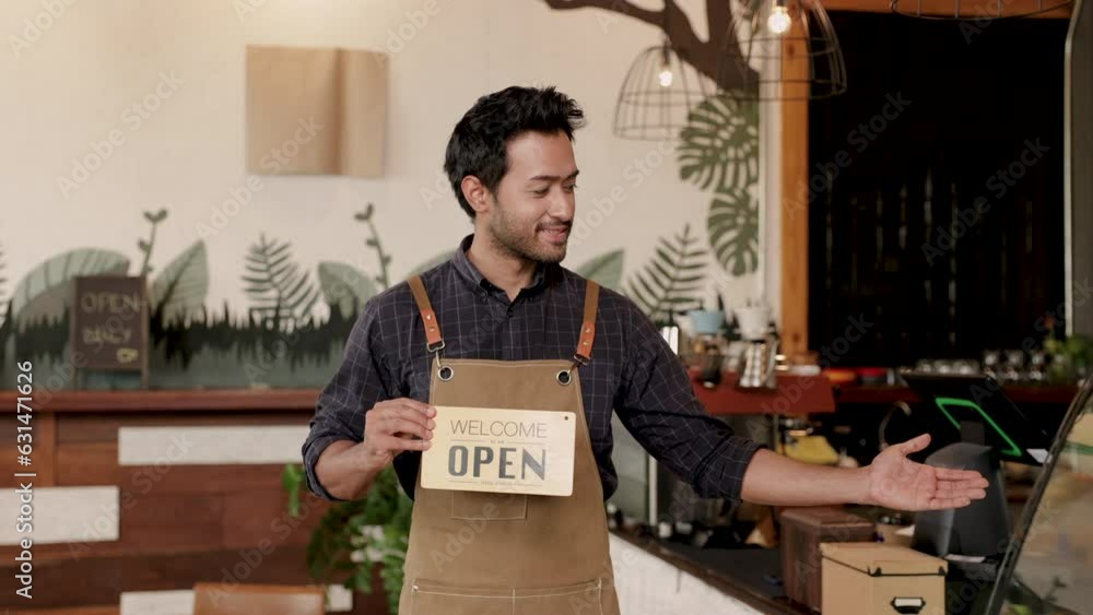 4k, Indian barista man smiling holds open signboard and spread hand ...