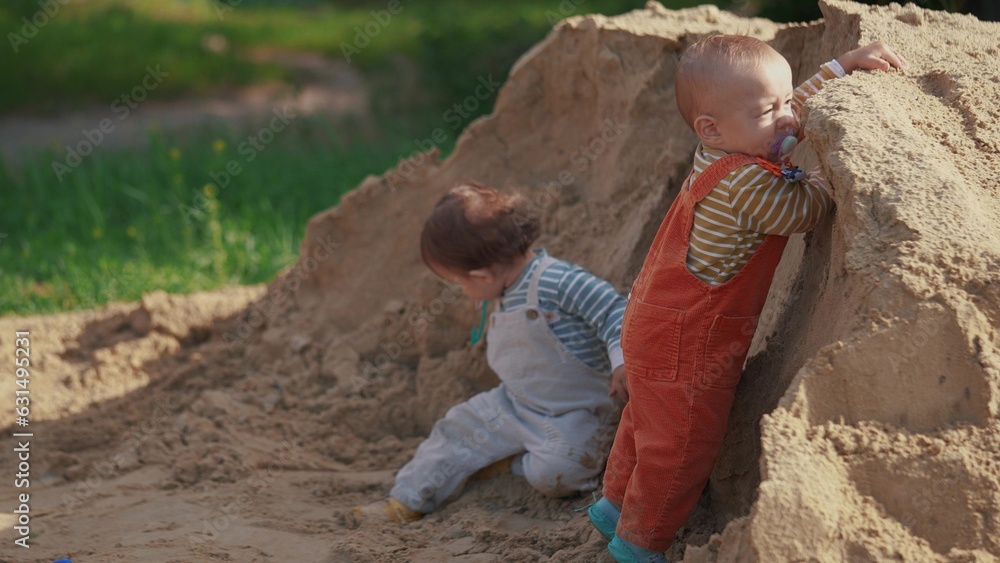 baby children play in the sand sandbox. happy family kid dream concept ...