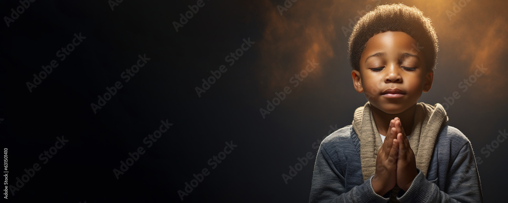 A young boy of African ethnicity praying. Christian religious prayer ...