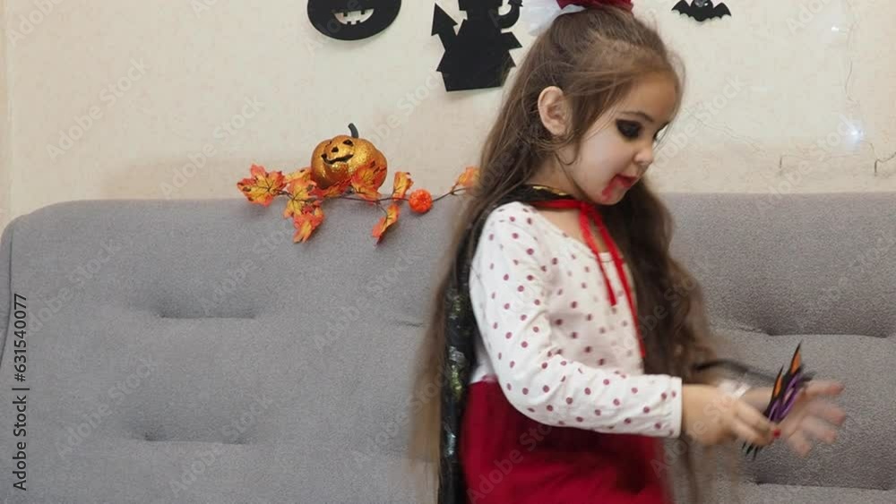 a girl with a vampire make-up, boy in a zombie costume eating scary ...