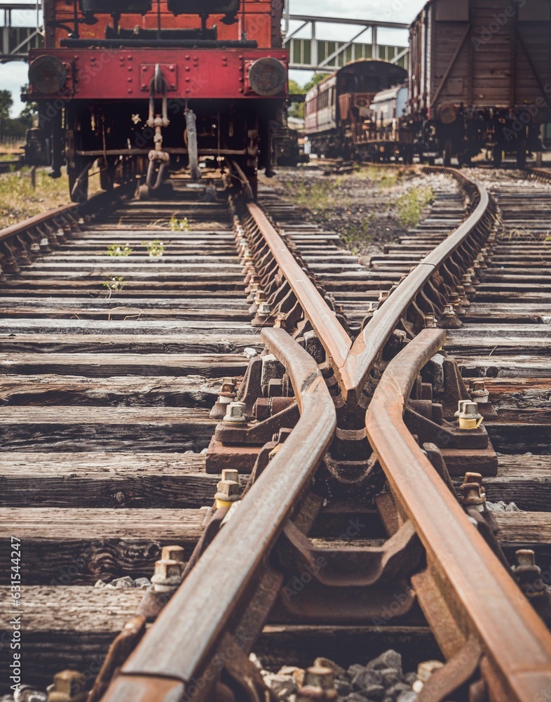Old train car pictured on a set of rusted railway tracks, with an aged ...