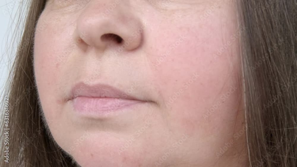 close-up of charismatic mature woman 50 years old looks carefully ...