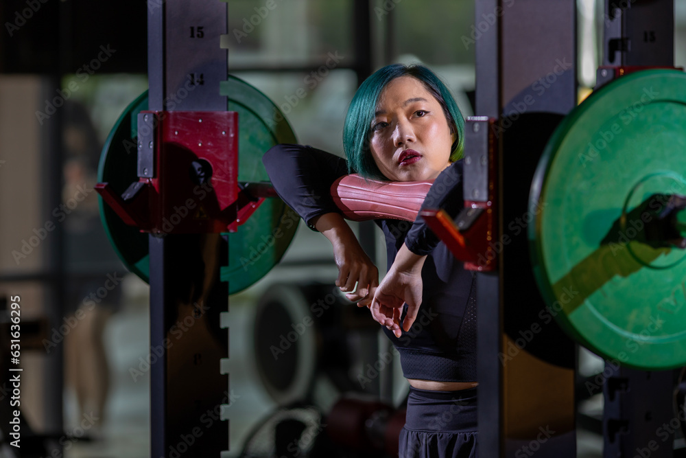 Asian woman is facing overtraining syndrome on practice weight lifting ...