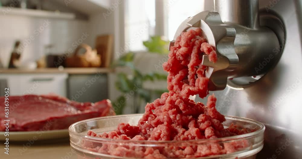 Electric meat grinder mince beef and pork meat in the kitchen in ...