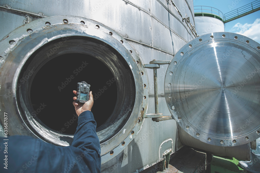 Worker hand holding gas detector inspection safety gas testing at front ...