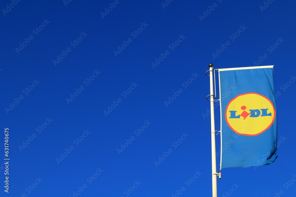 Lidl sign against a clear blue sky. Famous brand at a grocery store ...