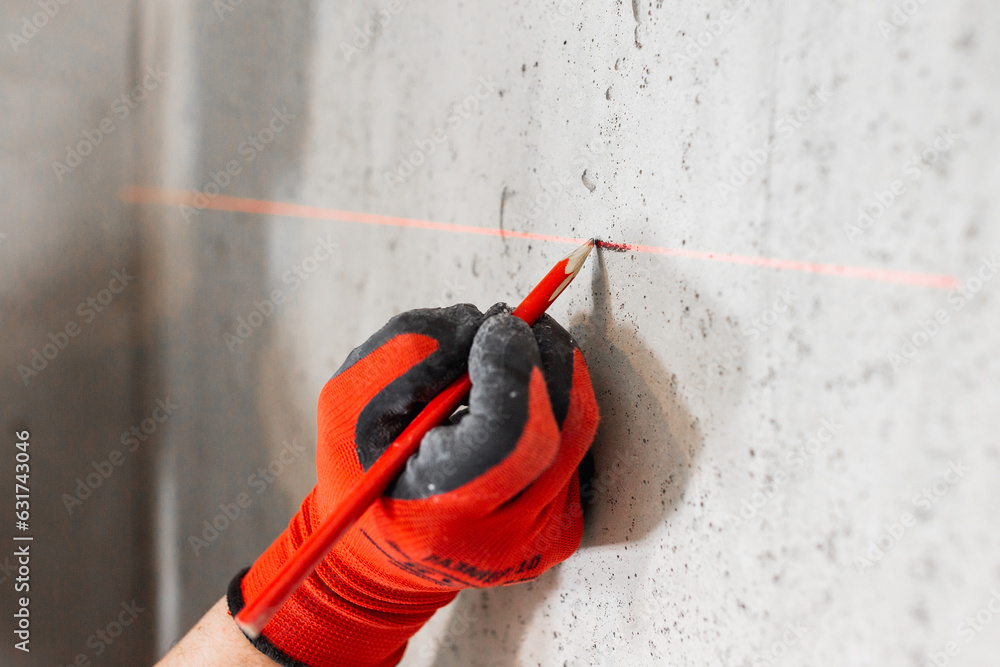Red smooth lines from the laser level - a high-tech construction tool ...