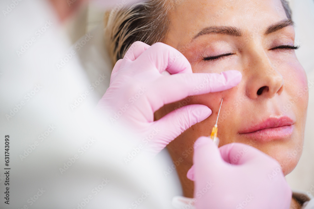 Subcutaneous injections of fillers with a syringe in a medical salon ...