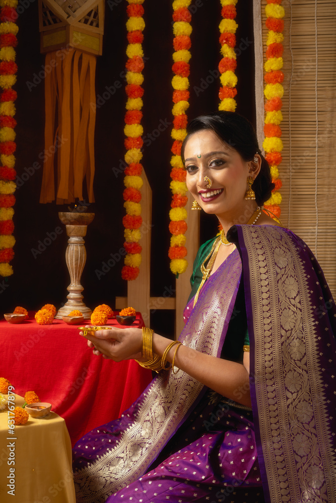 Portrait of Indian young lady performing Hindu rituals of pooja and ...