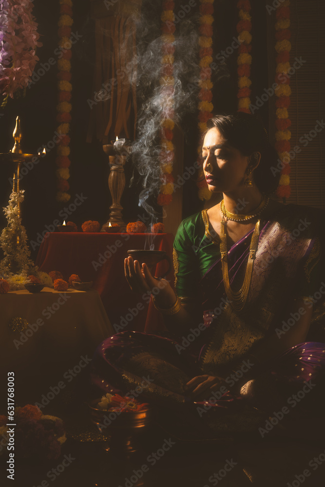Portrait of Indian young lady performing Hindu rituals of pooja and ...