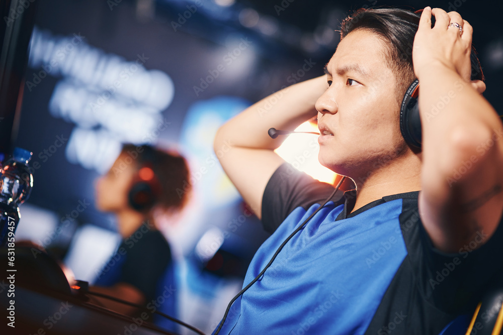 Side view of a confused asian guy, male cyber sport gamer wearing ...