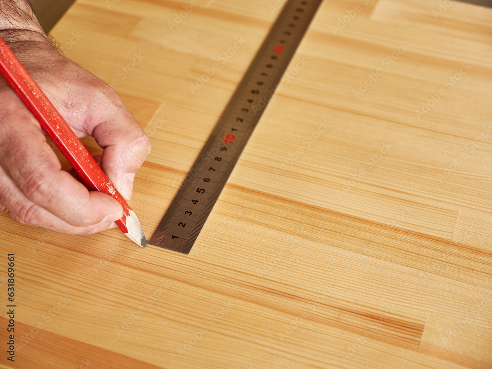 Using a tape measure and a ruler, measure the distance on the wooden ...