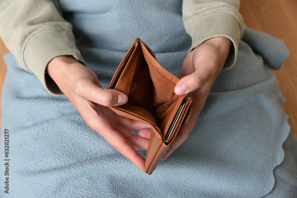 Eine Frau zeigt ihre leere Geldbörse Stock Photo | Adobe Stock