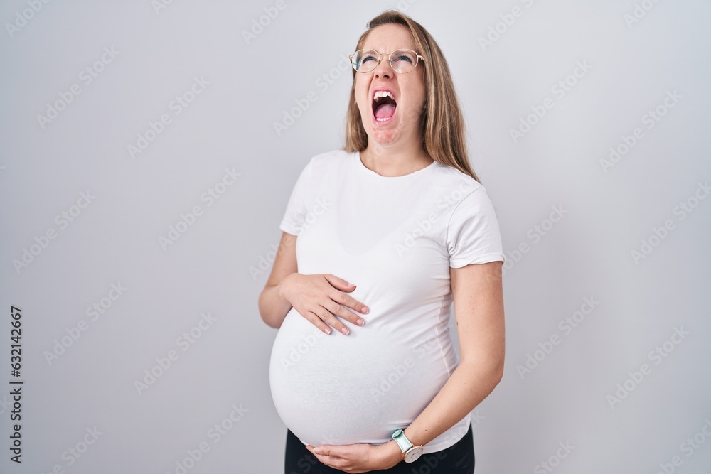 Young pregnant woman expecting a baby, touching pregnant belly angry ...