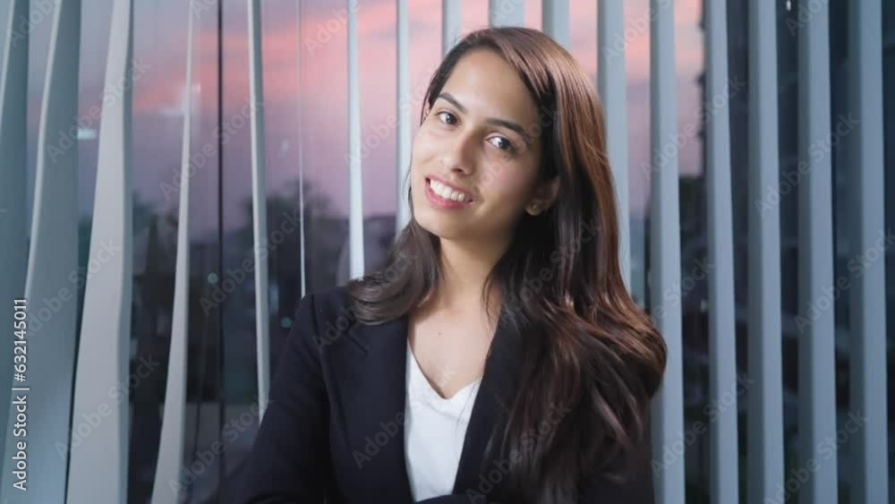 A young Asian Indian intern girl or female office employee is standing ...