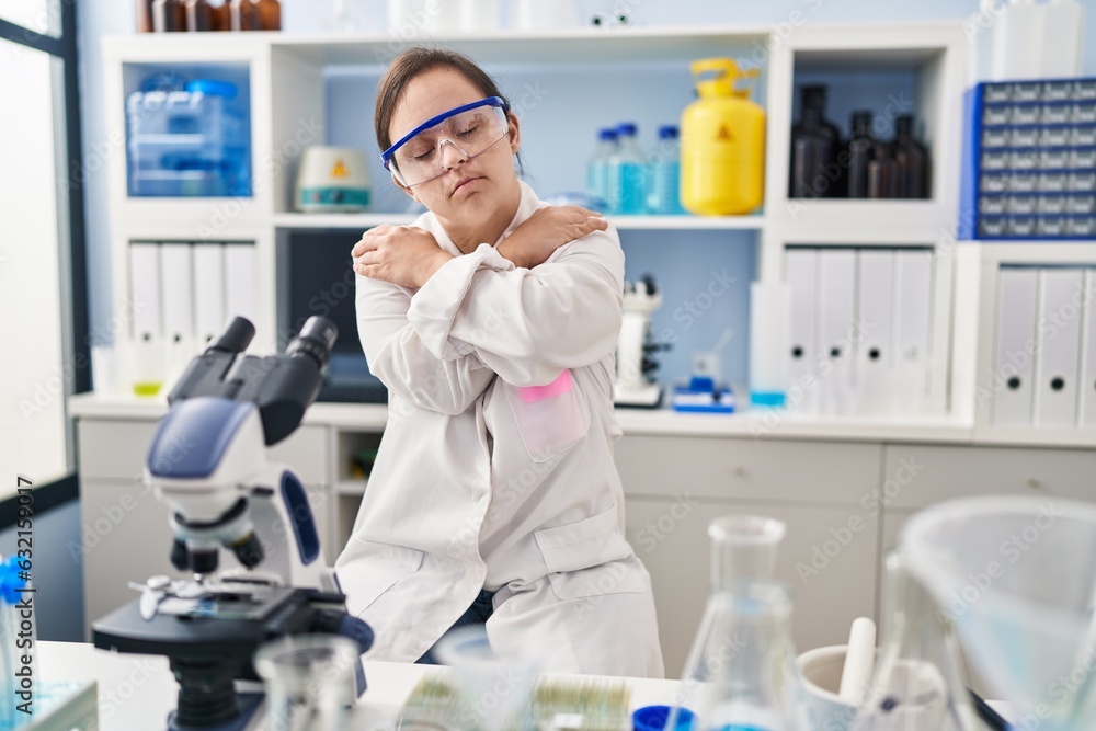 Hispanic girl with down syndrome working at scientist laboratory ...
