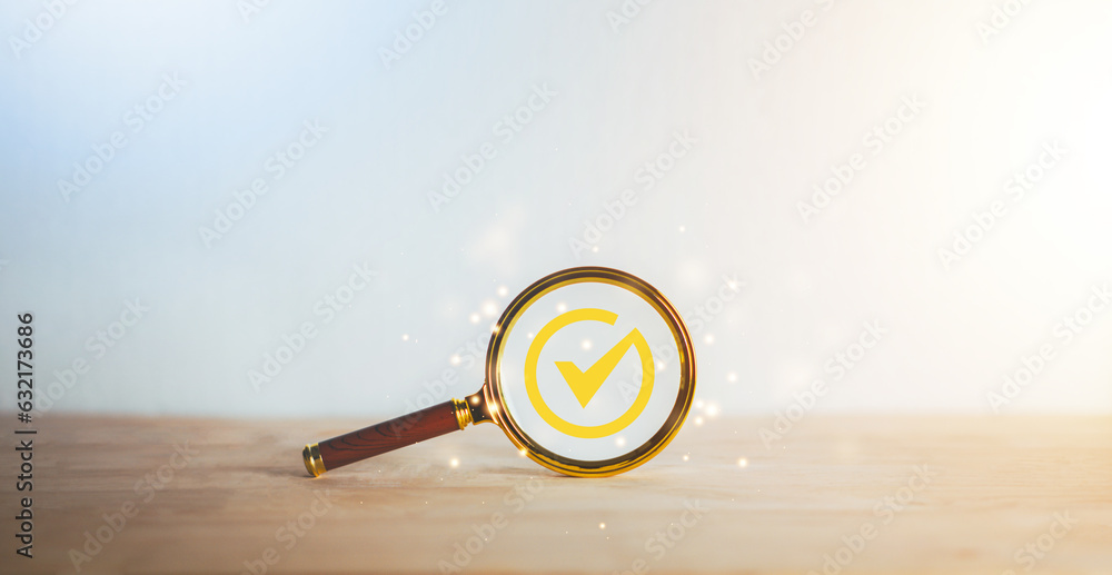 Magnifying glass with correct check marks on wooden table.Top service ...