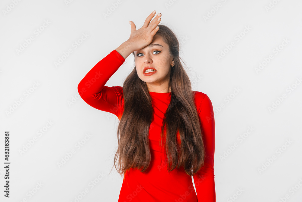 Oops. Lovely young woman makes mistake. Amazed surprised girl in red ...