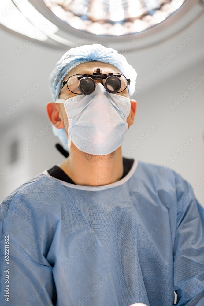 Surgeon with microscope glasses during an operation. Concept of real ...