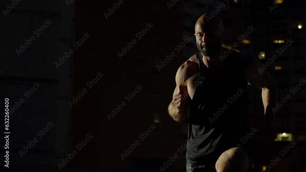 Close-up of an athlete running in one place in a night city. Circular ...