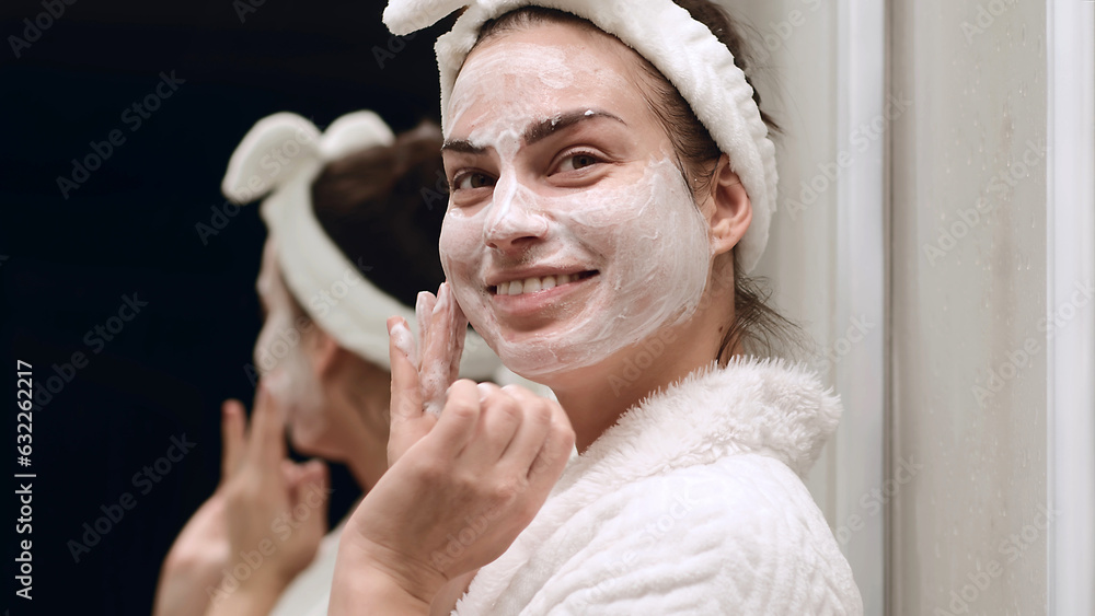 Woman is washing cleaning face with organic foamy soap cleanser ...
