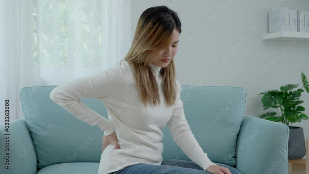 Asia beautiful woman holding her lower back while and suffer from ...
