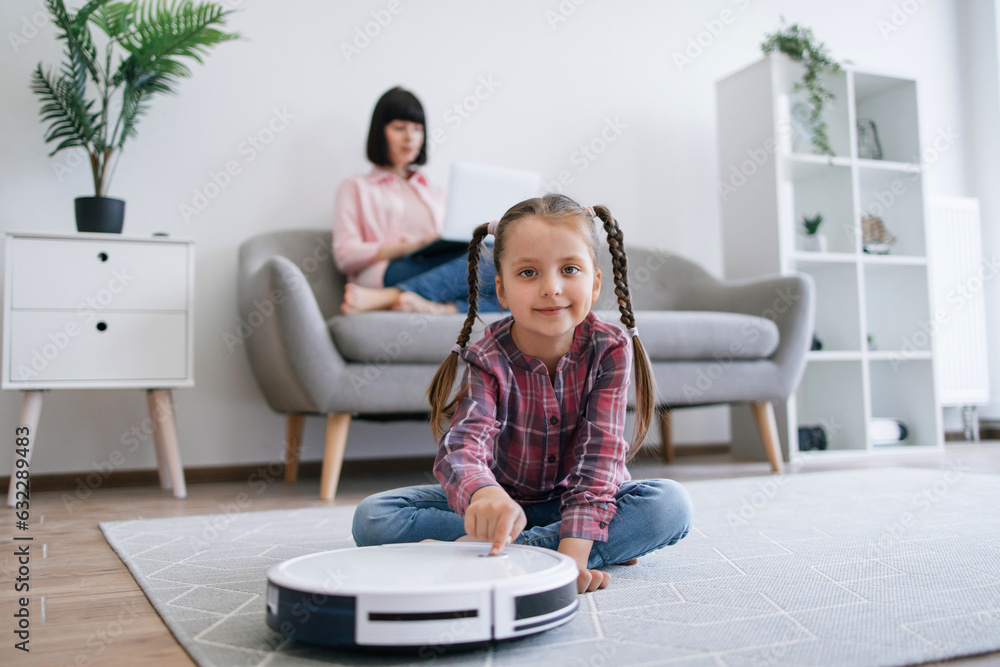 Portrait of girl with tightly braided hair activating an intelligent ...