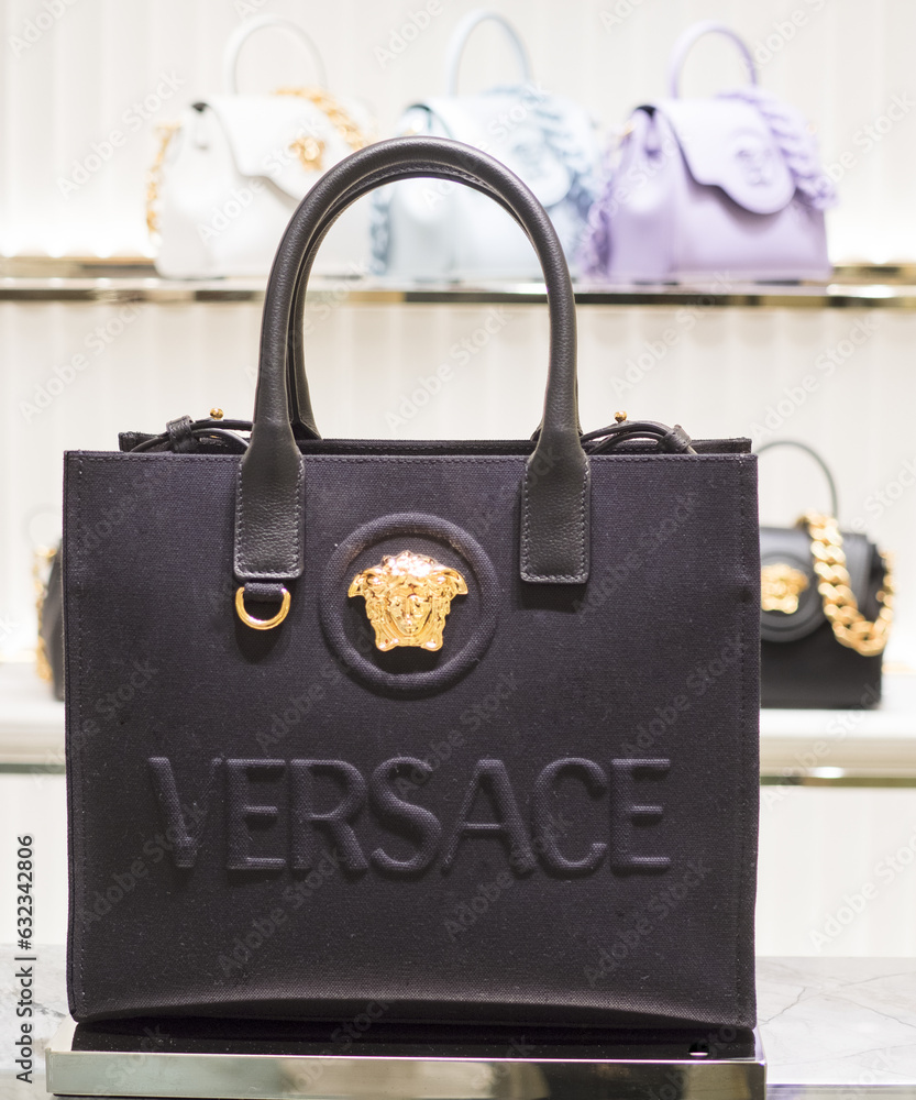 black fabric bag with golden Medusa and leather handle signed Versace ...