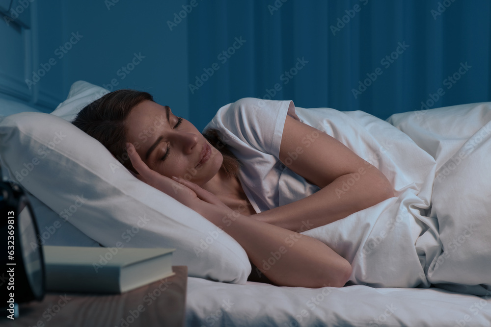 Beautiful woman sleeping in bed at night Stock Photo | Adobe Stock
