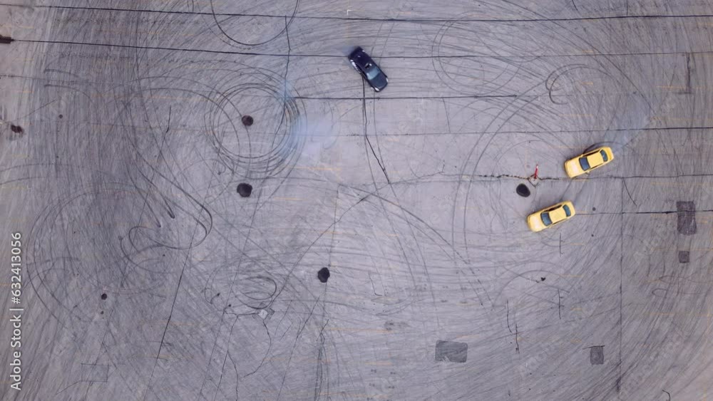 An Overhead Aerial View of a Black Drift Car Burning Rubber on in an ...