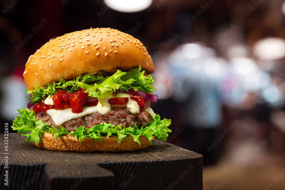 Fresh beef burger with lettuce, melted cheese, tomato, onion, ketchup ...