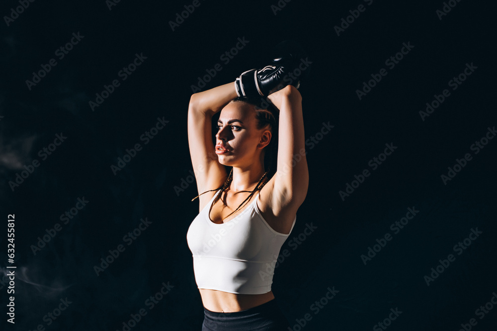 girl boxer standing in a confident pose surrounded by twilight. An ...