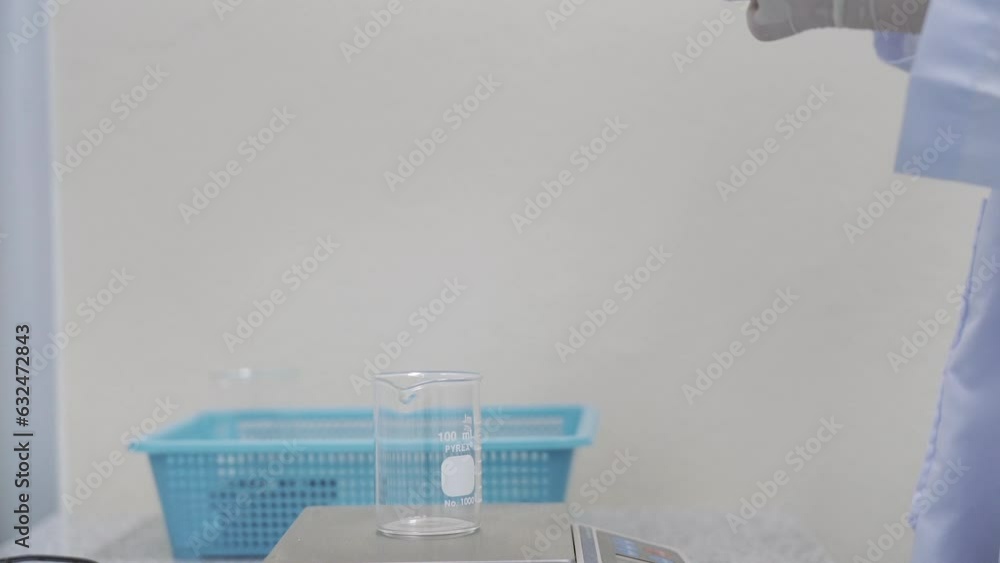 Scientist use spoon scoop white powder into beaker on scales Laboratory ...