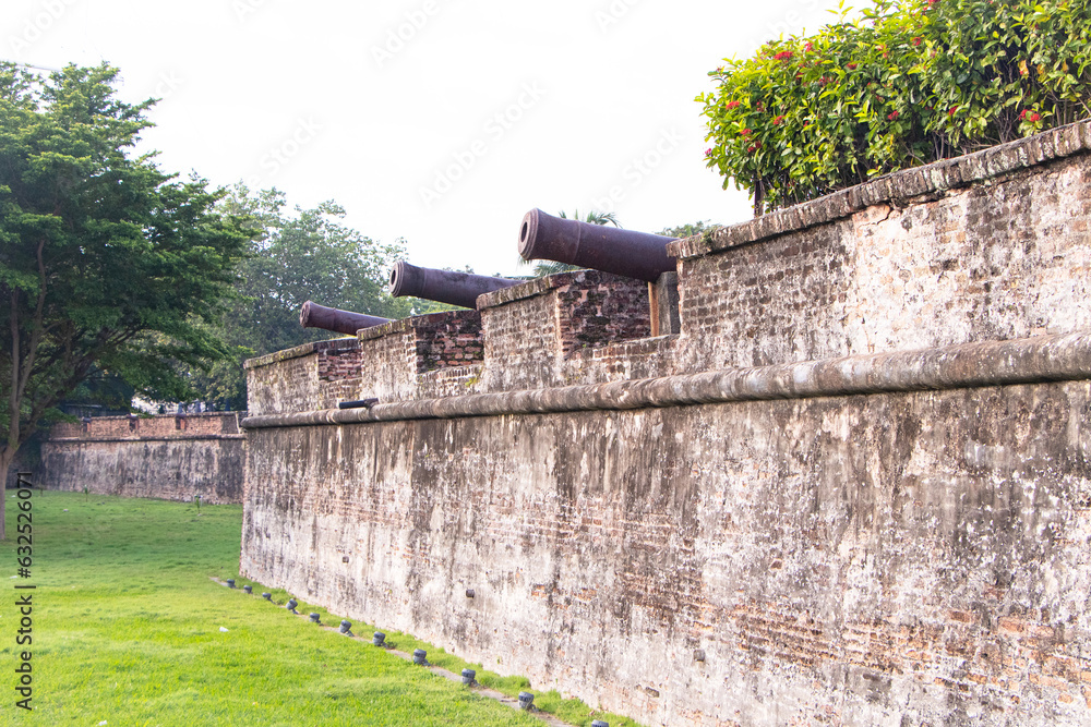 Old cannon on red brick wall is important historical site. Fort ...