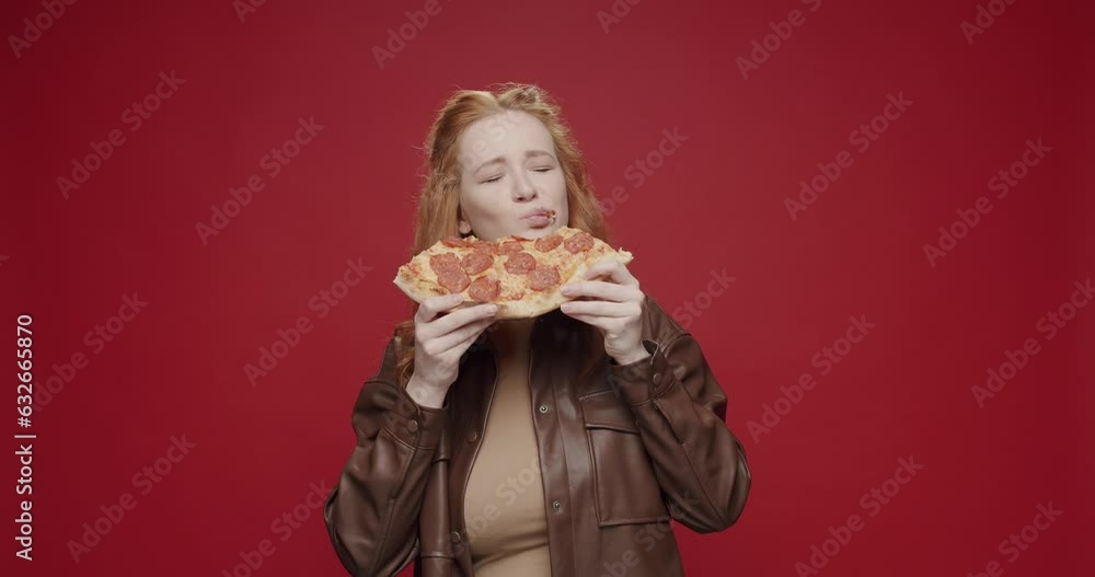The beautiful hungry girl eating pepperoni pizza, enjoy and smile on ...