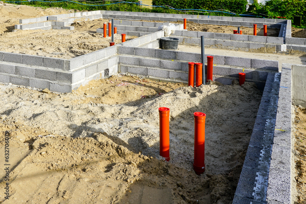 Poster Building the foundation of the house from concrete blocks and ...